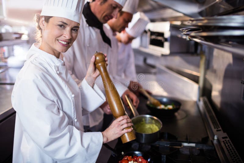 Chef Sprinkling Pepper on Tomatoes Stock Photo - Image of frying, chefs ...