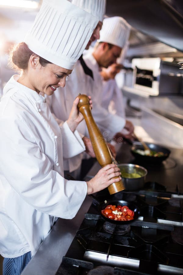 Chef Sprinkling Pepper on Tomatos Stock Image - Image of catering, chef ...