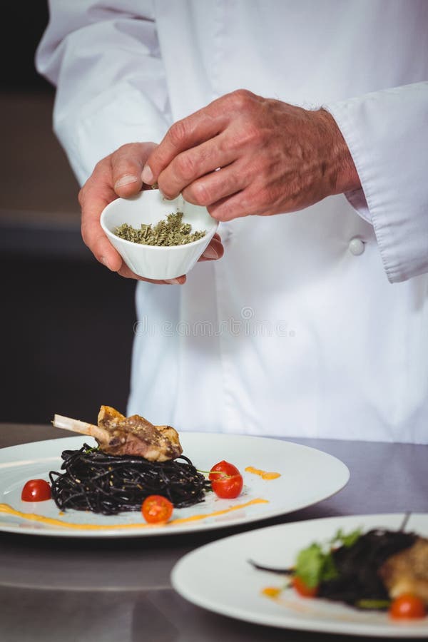 Chef Sprinkling Spices on Dish Stock Image - Image of indoors, hotel ...