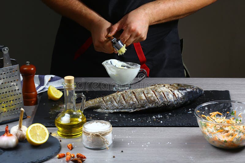 Chef Squeezes Garlic of Making Fish Sauce. Hands in the Process of ...