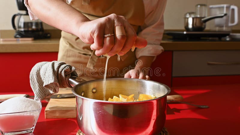 Chef Squeezes Lemon into Pot of Chopped Fruit in Modern Kitchen Stock ...