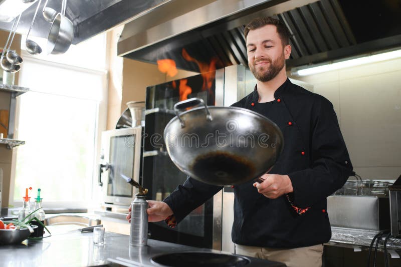 Chef Standing in Restaurant and Making Flambe on Frying Pan Stock Image ...