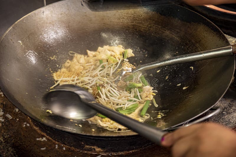 The Chef is Stir-frying Pad Thai in a Wok in the Kitchen. Stock Photo ...