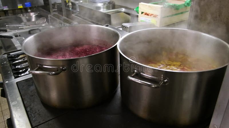 Chef Stirring Steaming Pots of Simmering Red and Yellow Soups in ...
