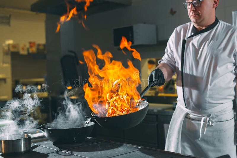 Chef is Stirring Vegetables in Work on the Kitchen. Stock Image - Image ...