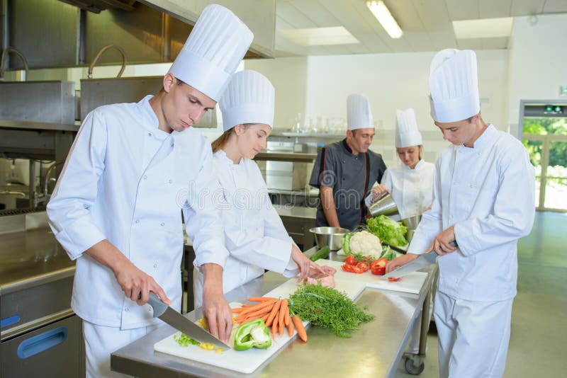 Chef Supervising Trainees Cooking Stock Image - Image of catering, cook ...