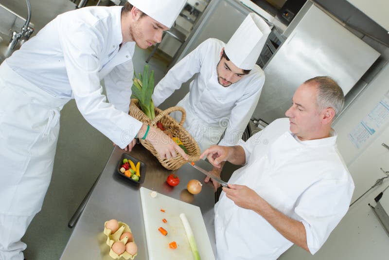 Chef Supervising Trainees Cooking Stock Photo - Image of food ...