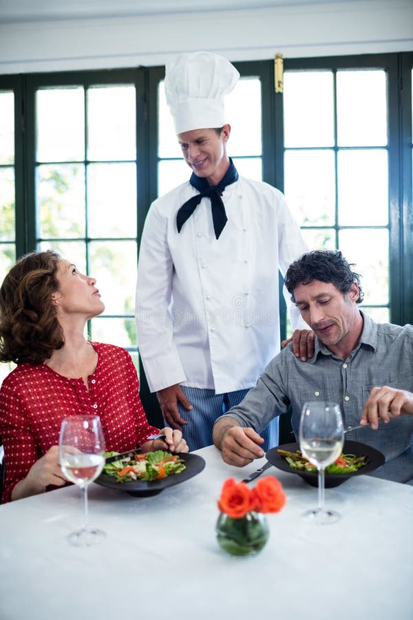 Chef talking to couple stock image. Image of couple, gourmet - 68272697