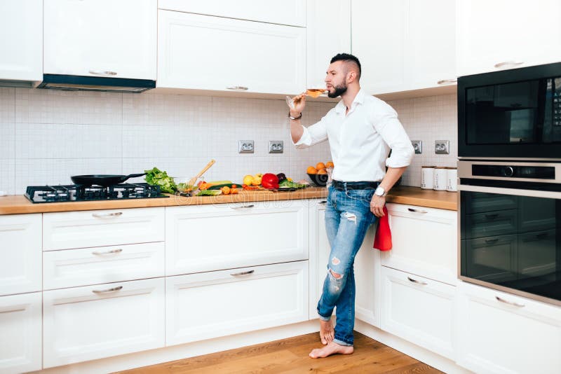 Chef Tasting Wine before Dinner. Male Cook Preparing Salad and Drinking ...