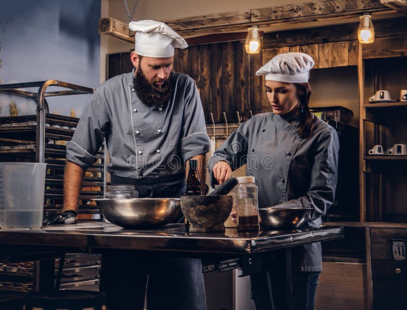 Chef Teaching His Assistant To Bake the Bread in the Bakery. Stock ...