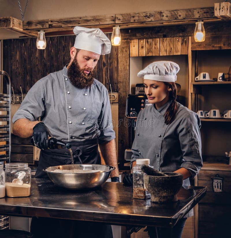 Chef Teaching His Assistant To Bake the Bread in a Bakery. Stock Image ...