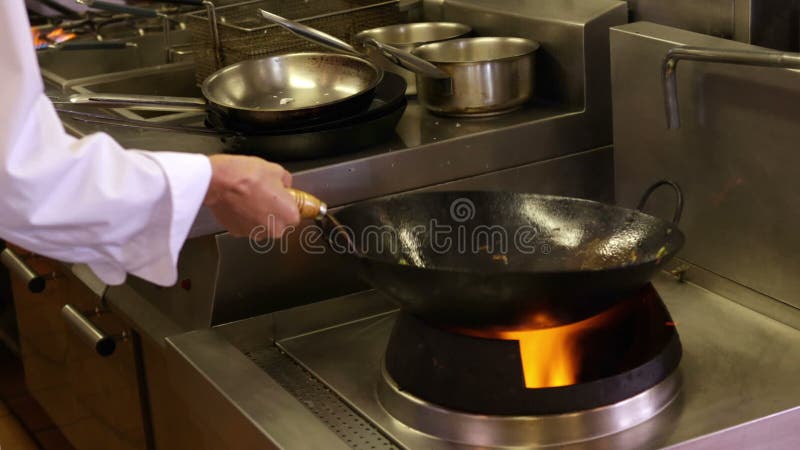 A Large Flame Erupts from a Steel Pan on a Gas Stove in a Modern ...