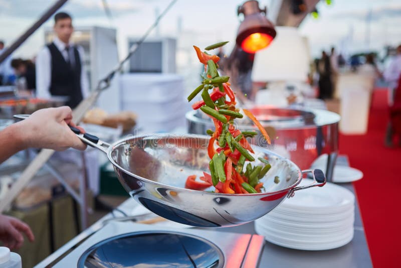 Chef Tossing Vegetables in a Wok in an Outdoor Kitchen. Stock Image ...