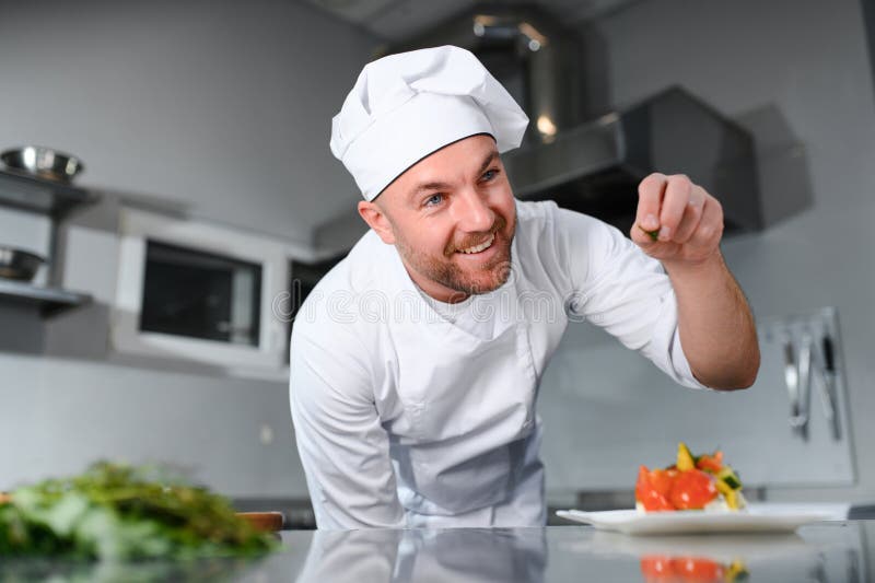 Chef in Uniform Cooking at the Restaurant Kitchen Stock Photo - Image ...