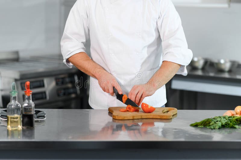 Chef in Uniform Cooking at the Restaurant Kitchen Stock Photo - Image ...