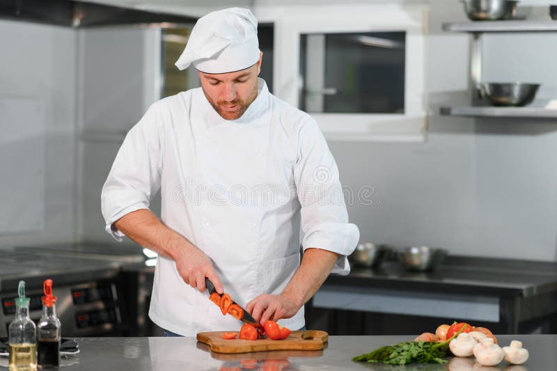 Chef in Uniform Cooking at the Restaurant Kitchen Stock Photo - Image ...