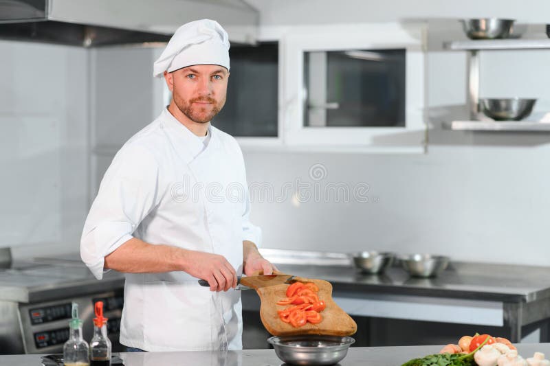 Chef in Uniform Cooking at the Restaurant Kitchen Stock Image - Image ...