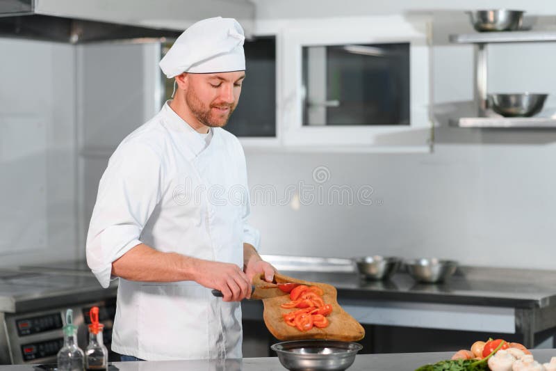 Chef in Uniform Cooking at the Restaurant Kitchen Stock Photo - Image ...