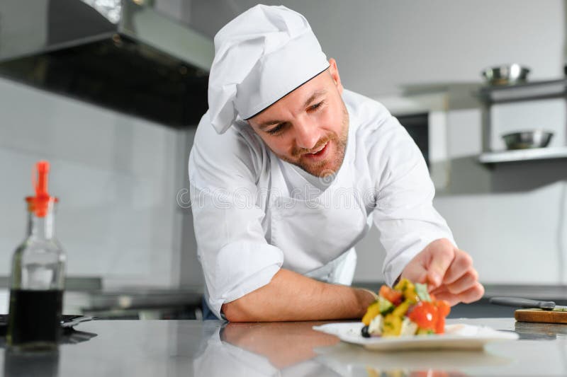 Chef in Uniform Cooking at the Restaurant Kitchen Stock Image - Image ...