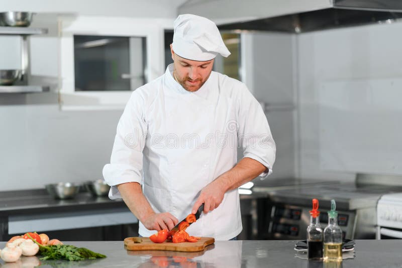 Chef in Uniform Cooking at the Restaurant Kitchen Stock Photo - Image ...