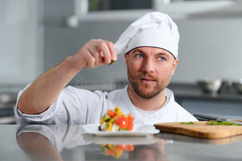 Chef in Uniform Cooking at the Restaurant Kitchen Stock Image - Image ...
