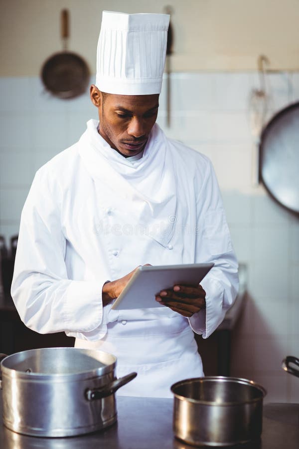 Chef using digital tablet stock photo. Image of expertise - 77688310
