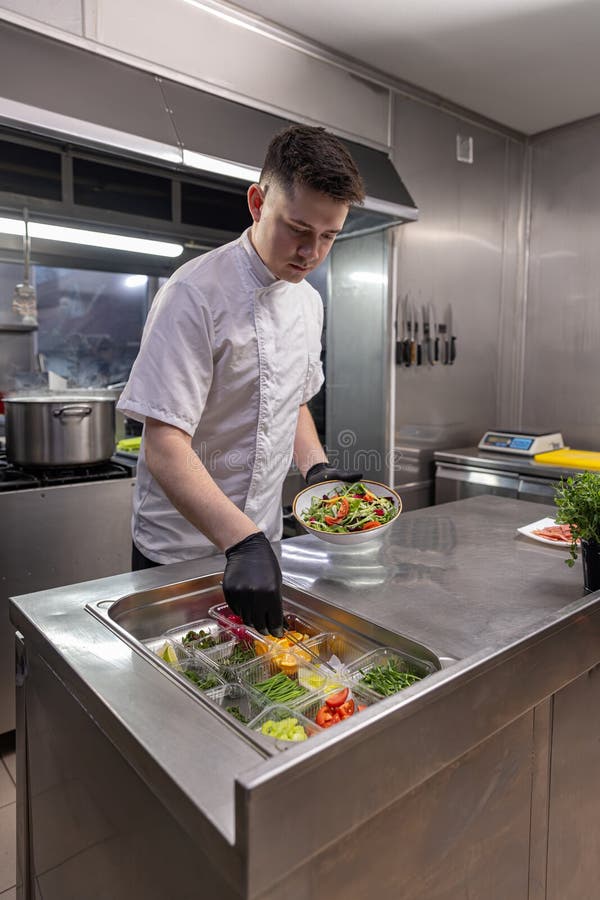 Chef Using Tongs and Holding Plate Stock Image - Image of container ...