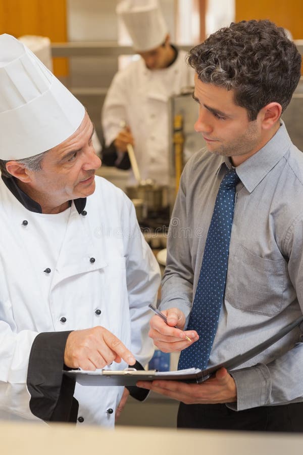 Chef and Waiter Having a Discussion Stock Image - Image of caucasian ...