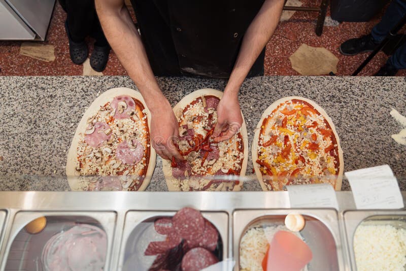 Chef at Work: Crafting Pizzas with Assorted Toppings Stock Image ...