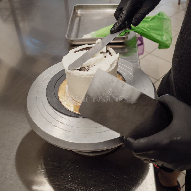 Chef Smoothing a Forsted Cake with Buttercream, Spatula and Wrench ...