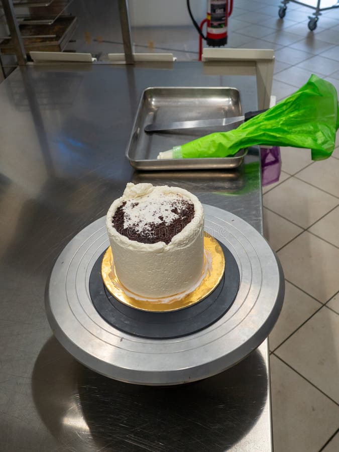Chef Smoothing a Forsted Cake with Buttercream, Spatula and Wrench ...