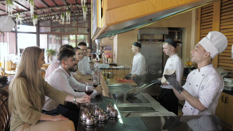 Chefs Cook in White Uniform for Clients on the Bar Table at the Open ...