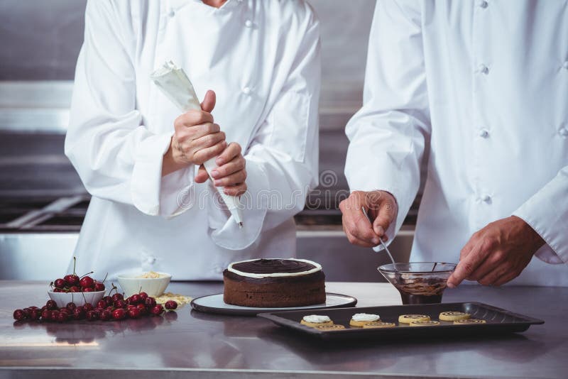 Chefs decorating a cake stock photo. Image of food, dessert - 68241532