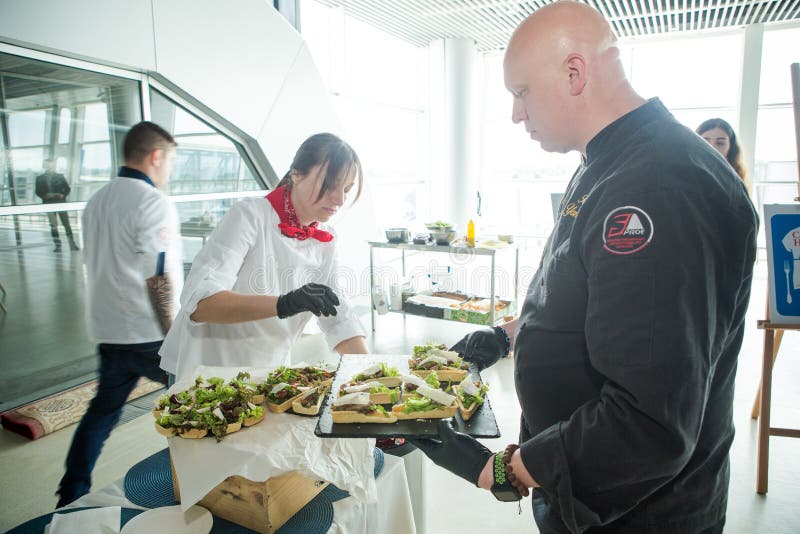 Chefs in Different Uniforms Serving Snacks on Table for Degustation in ...
