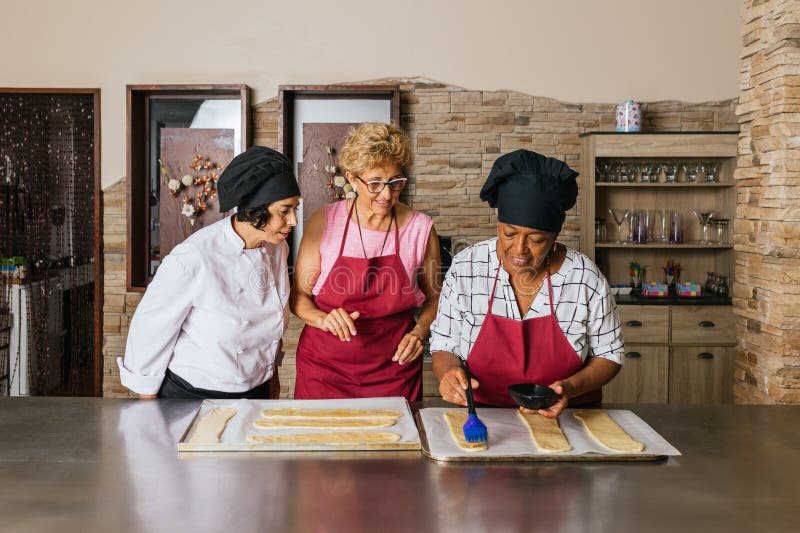 Chefs Guiding Student Brushing Pastry in Cooking Class Stock Image ...