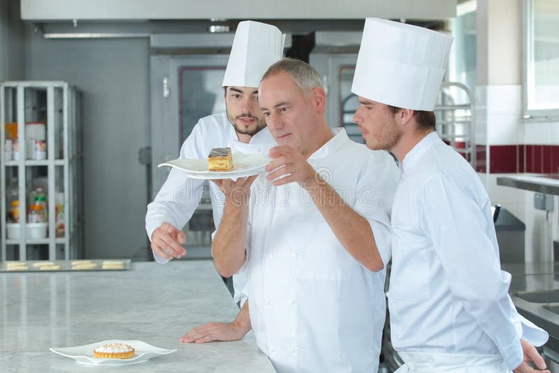 Apprentices Chefs at Work with Experienced Master Stock Photo - Image ...