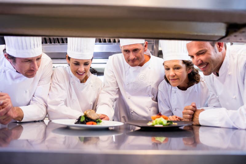 Chefs Looking at the Dish Prepared by Them Stock Photo - Image of ...