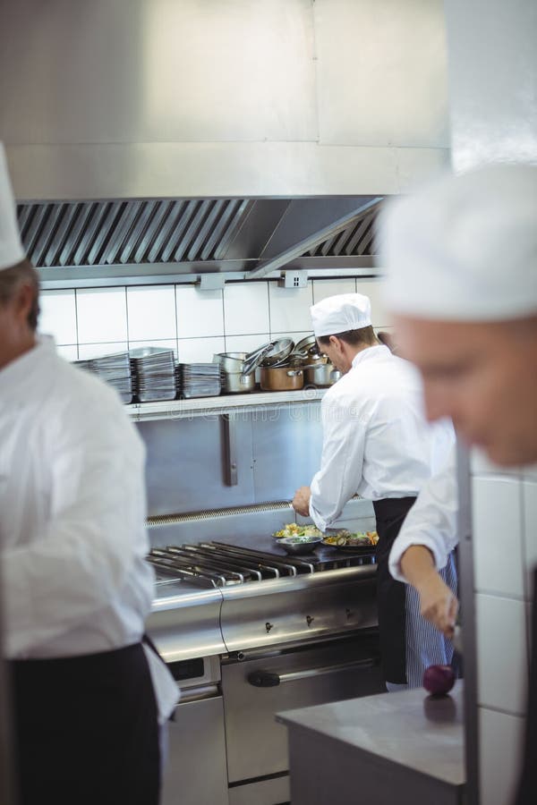 Chefs Preparing Food in the Commercial Kitchen Stock Photo - Image of ...