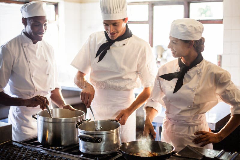 Chefs Preparing Food at Stove Stock Image - Image of female ...