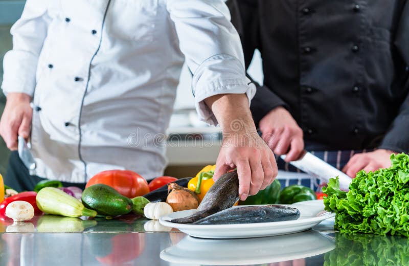 Chefs Preparing Food in Teamwork at Restaurant Kitchen Stock Image ...