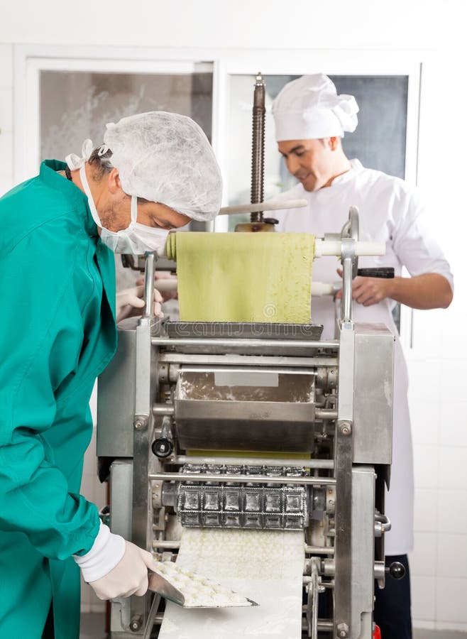 Chefs Processing Ravioli Pasta in Machine Stock Photo - Image of ...