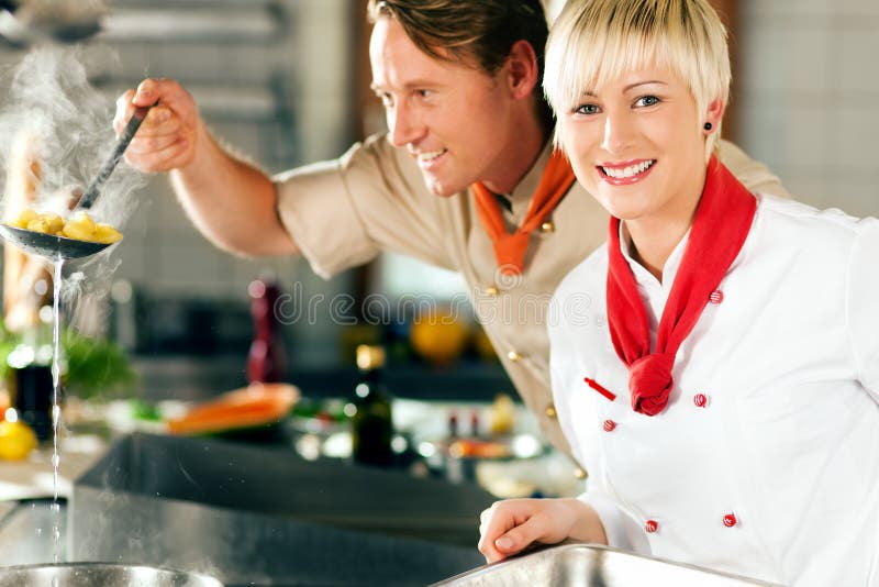 Chefs in a Restaurant or Hotel Kitchen Cooking Stock Image - Image of ...