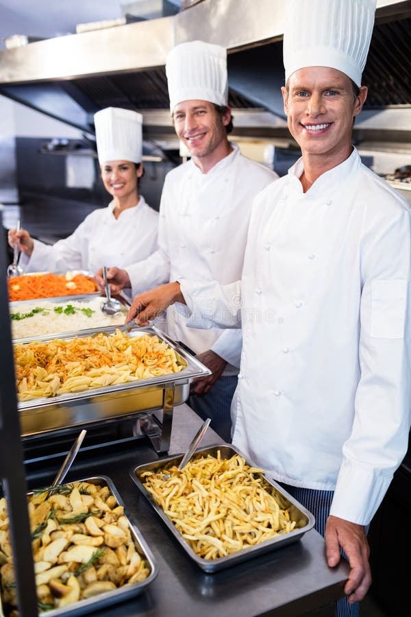 Chefs Standing at Serving Trays of Pasta Stock Photo - Image of holding ...
