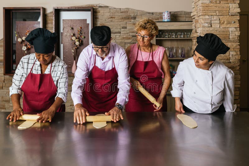 Chefs and Students Flattening Dough with Rolling Pin in Restaurant ...
