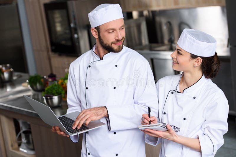Chefs Using Laptop at Restaurant Kitchen Stock Image - Image of ...