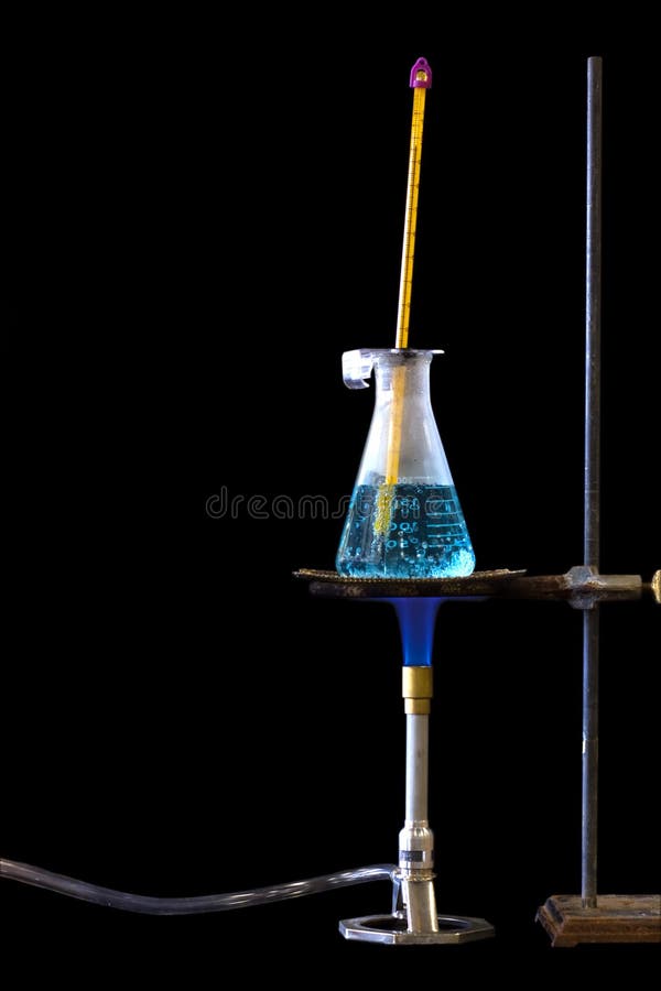 Bunsen Burner Heating Flask with Science Equipment in Laboratory Stock ...
