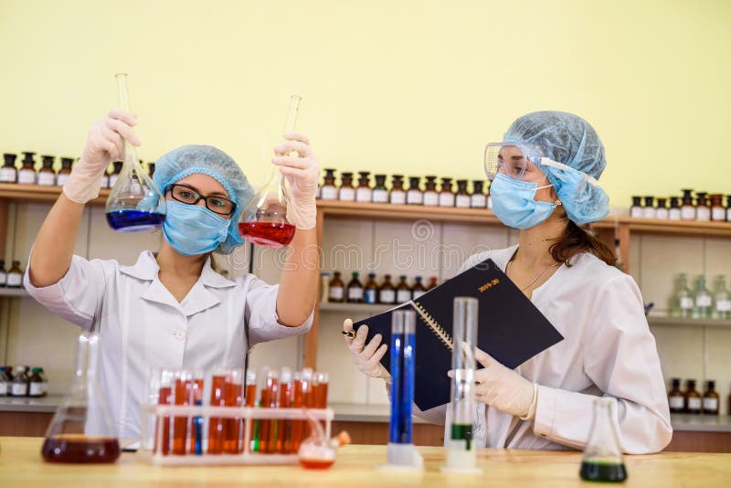 Chemical Equipment and Two Chemists Behind Making Experiment in ...