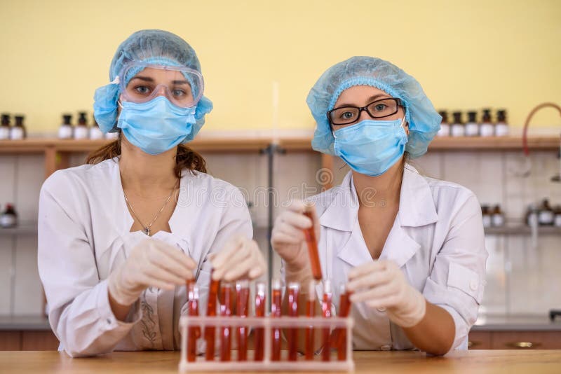 Chemical Equipment and Two Chemists Behind Making Experiment in ...