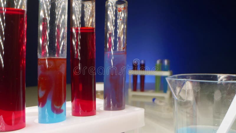 Chemical Experiments. Red Liquid Dissolves in a Clear Liquid in a Test ...