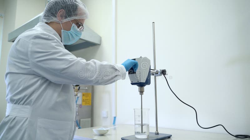 Male Chemist Mixing Powder and Liqiuid in Chemical Mixing Magnetic ...
